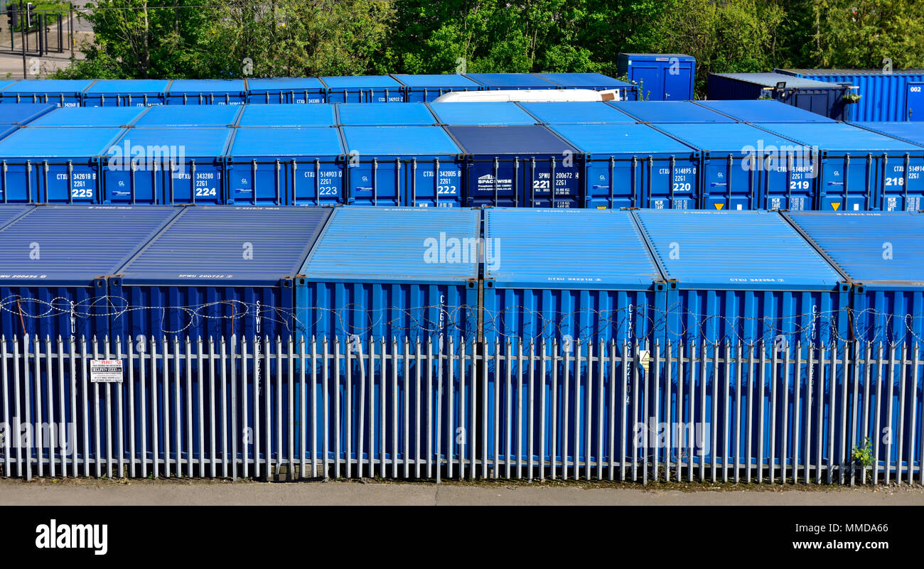 Blue painted steel shipping containers used for storage Stock Photo - Alamy