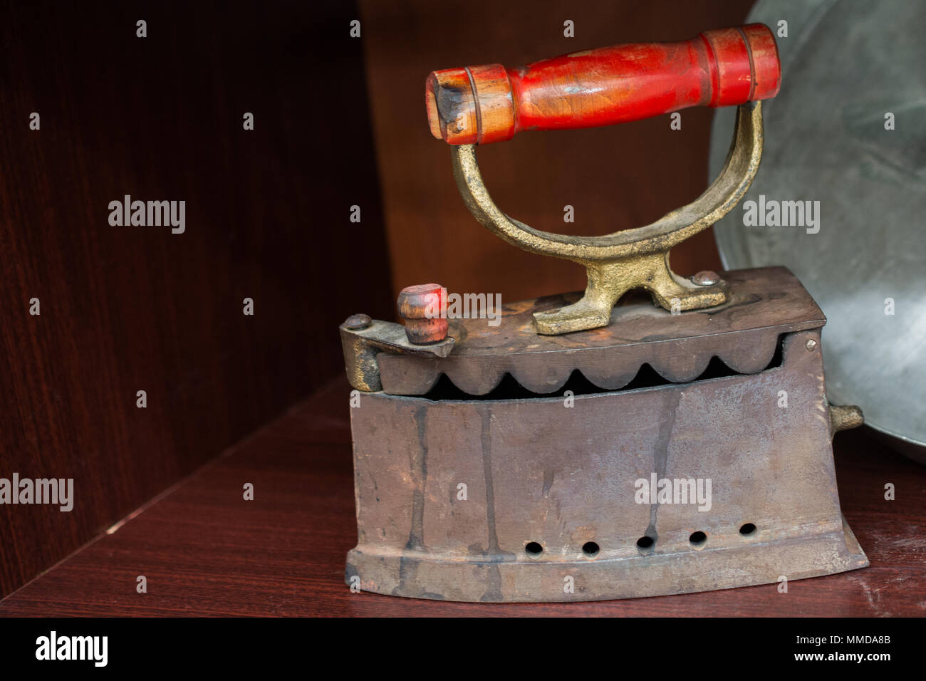 Retro metallized heavy antique iron tool for ironing Stock Photo - Alamy