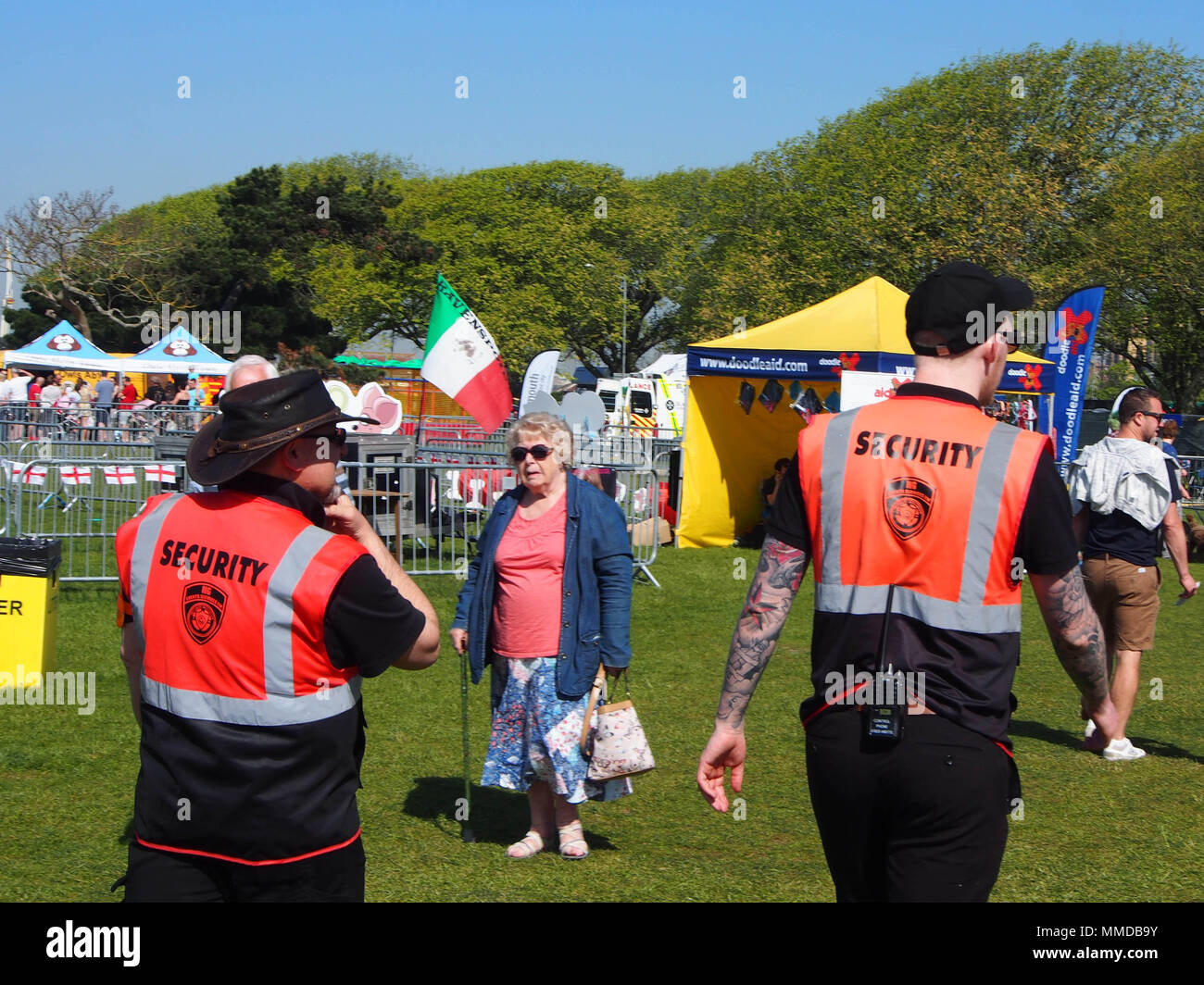 Two security guard patrol a public outdoor event Stock Photo - Alamy