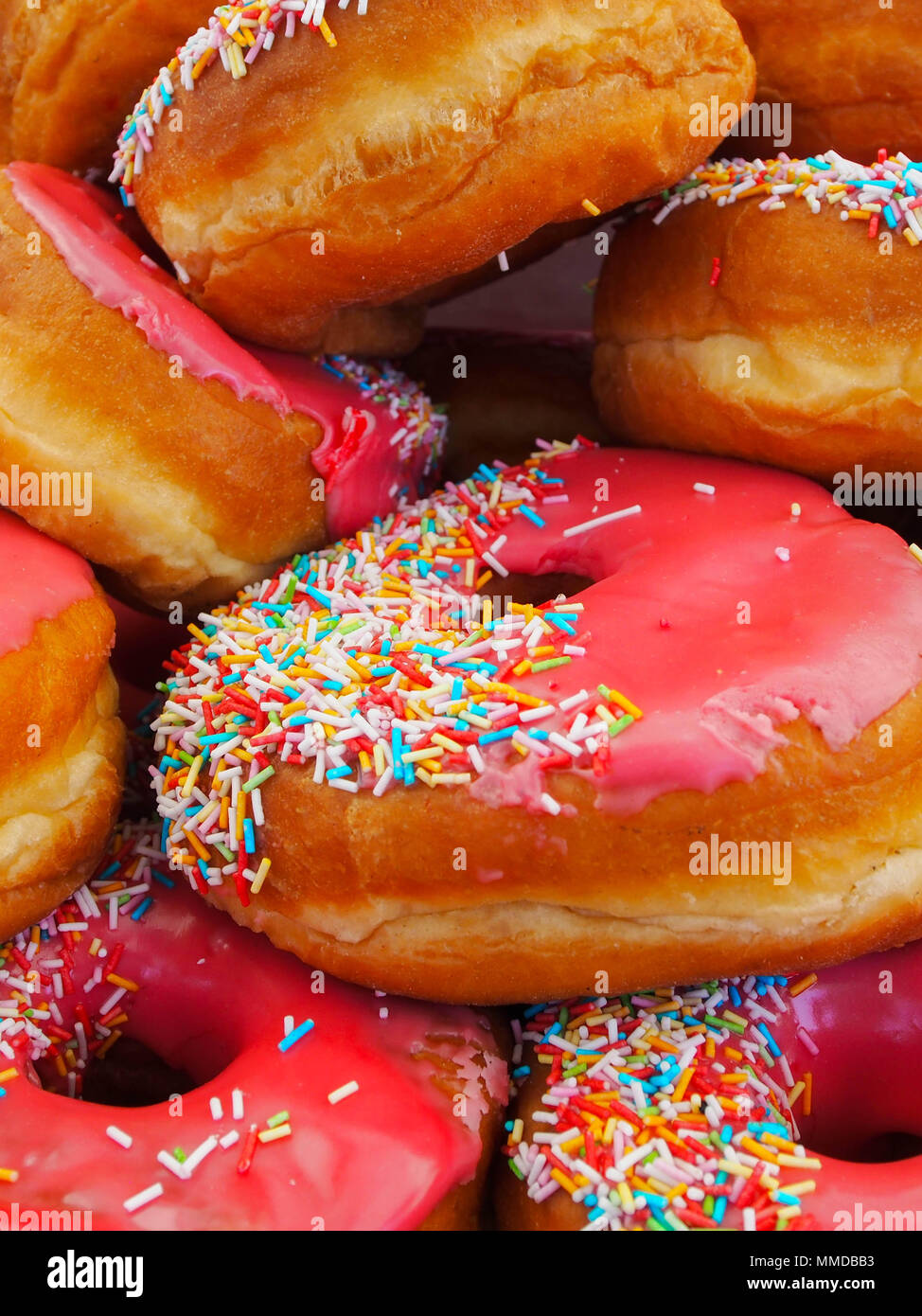 Pink iced ring doughnuts Stock Photo - Alamy