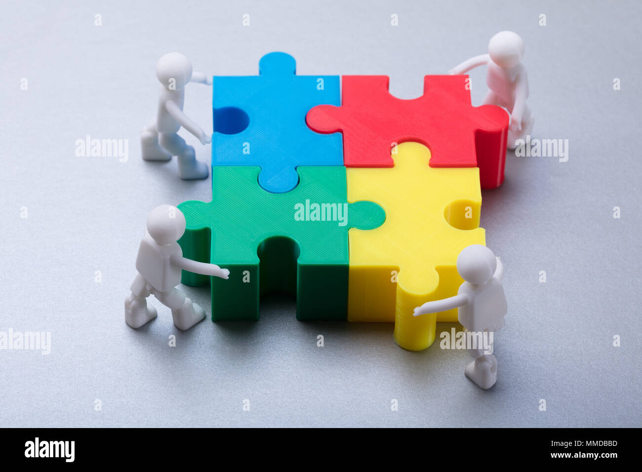 Human Figures Solving Multicolored Jigsaw Puzzle On Grey Background ...