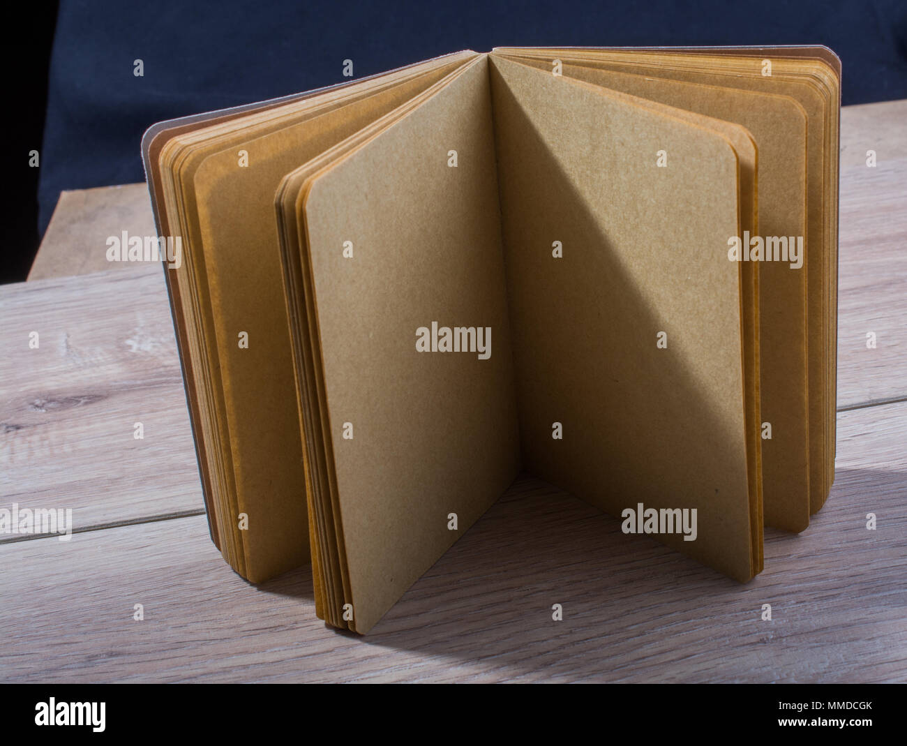 Brown color notebook open on a black background Stock Photo - Alamy