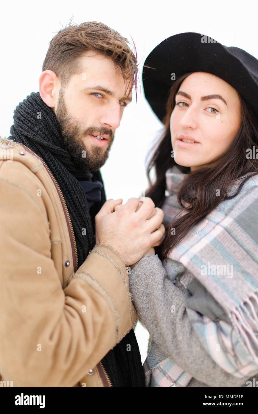Portrait of american couple wearing scarf and hat in white background ...