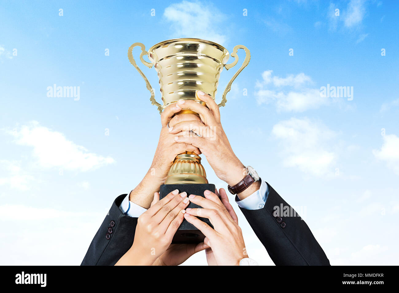 Team hands holding trophy hi-res stock photography and images - Alamy