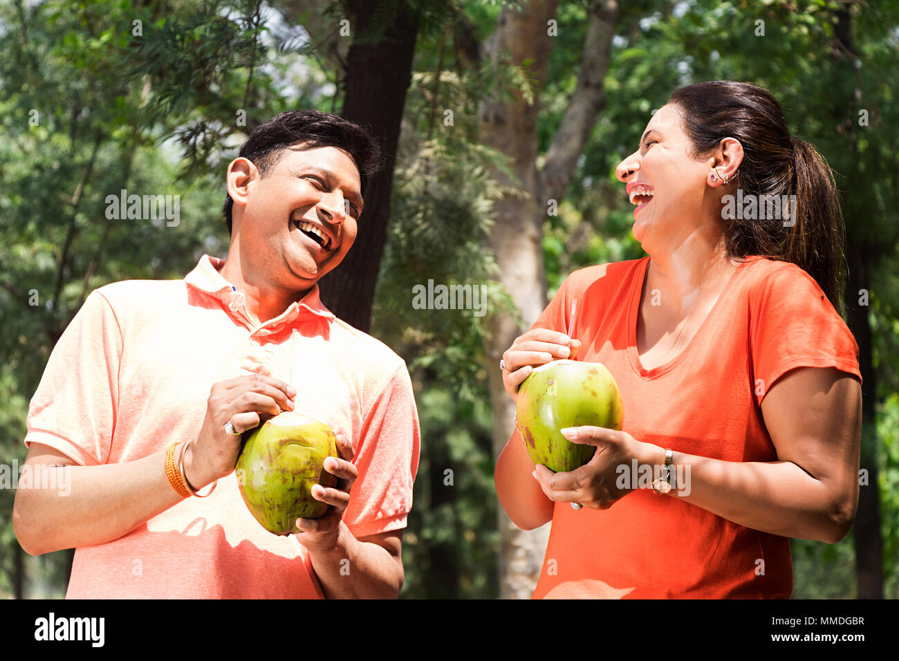 Adult Man And Woman Couple Drinking Coconut Water While Talking Fun In ...