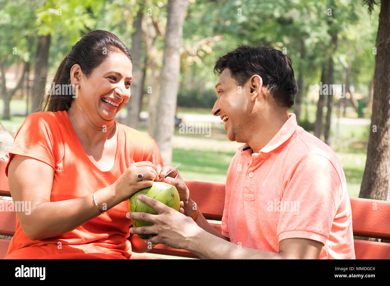 Two Couple Sitting Bench Drinking Coconut Water Fun Cheerful In-Park ...