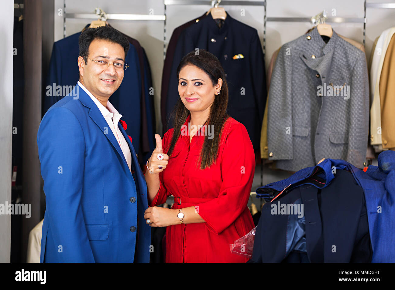 Happy Married-Couple Checking Coat Showing Thumbs-Up Shopping Buy In ...