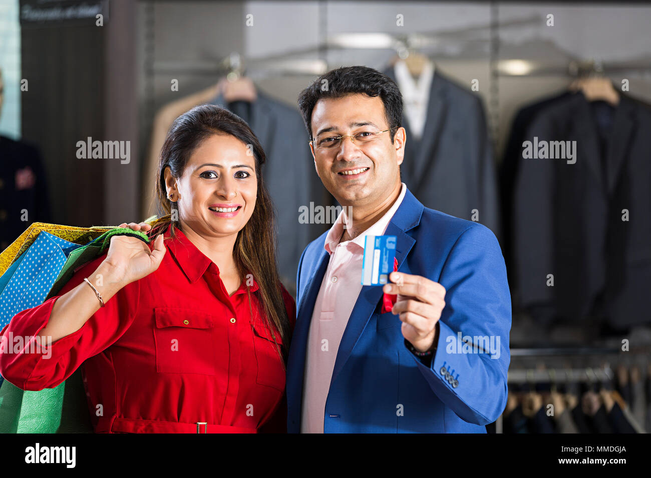 Happy Couple Holding Showing Debit-Card With Shopping Bag In-Shop m all ...