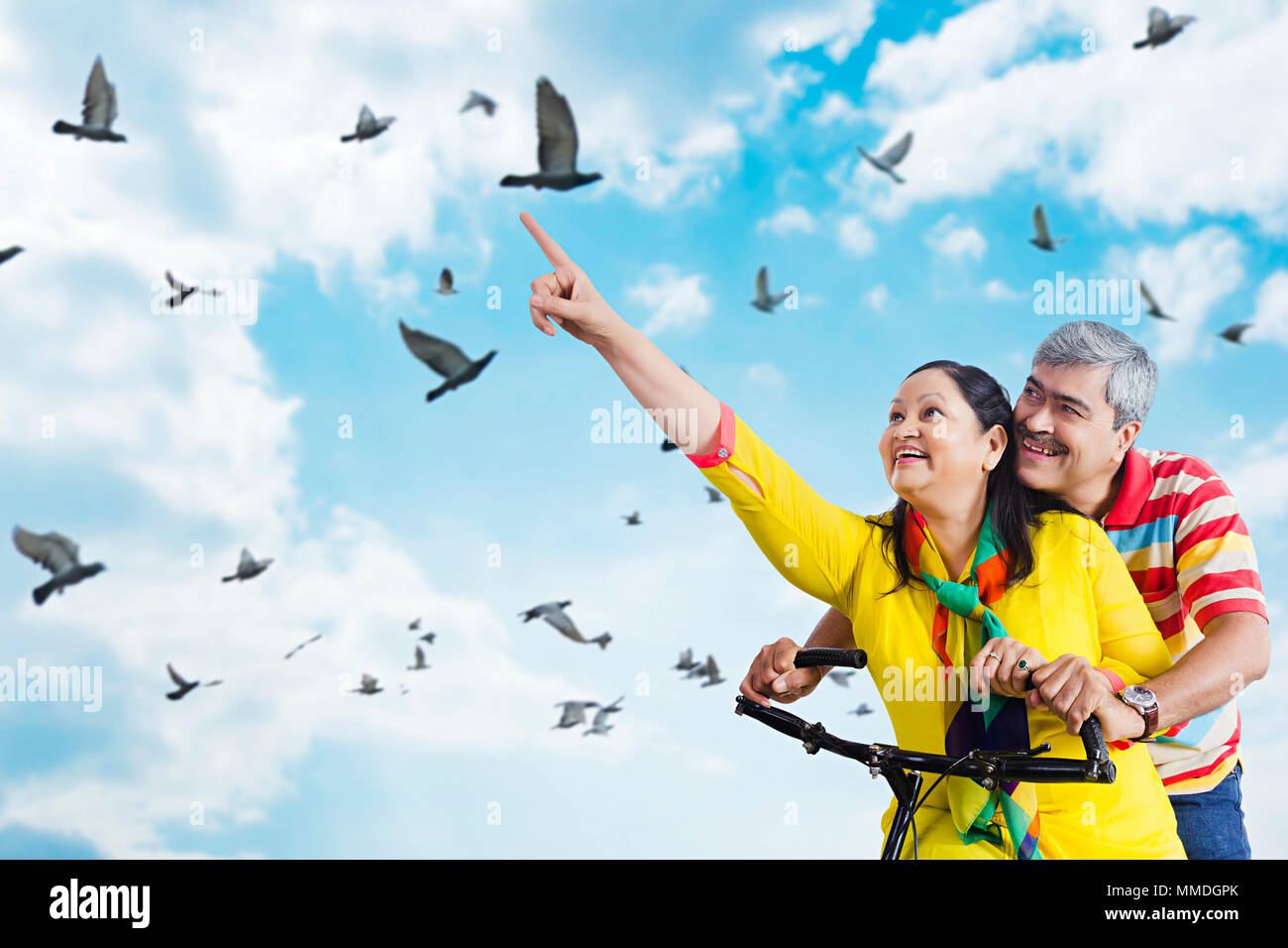 Happy Senior Couple Pointing-Finger Showing Birds Riding Cycle Together ...