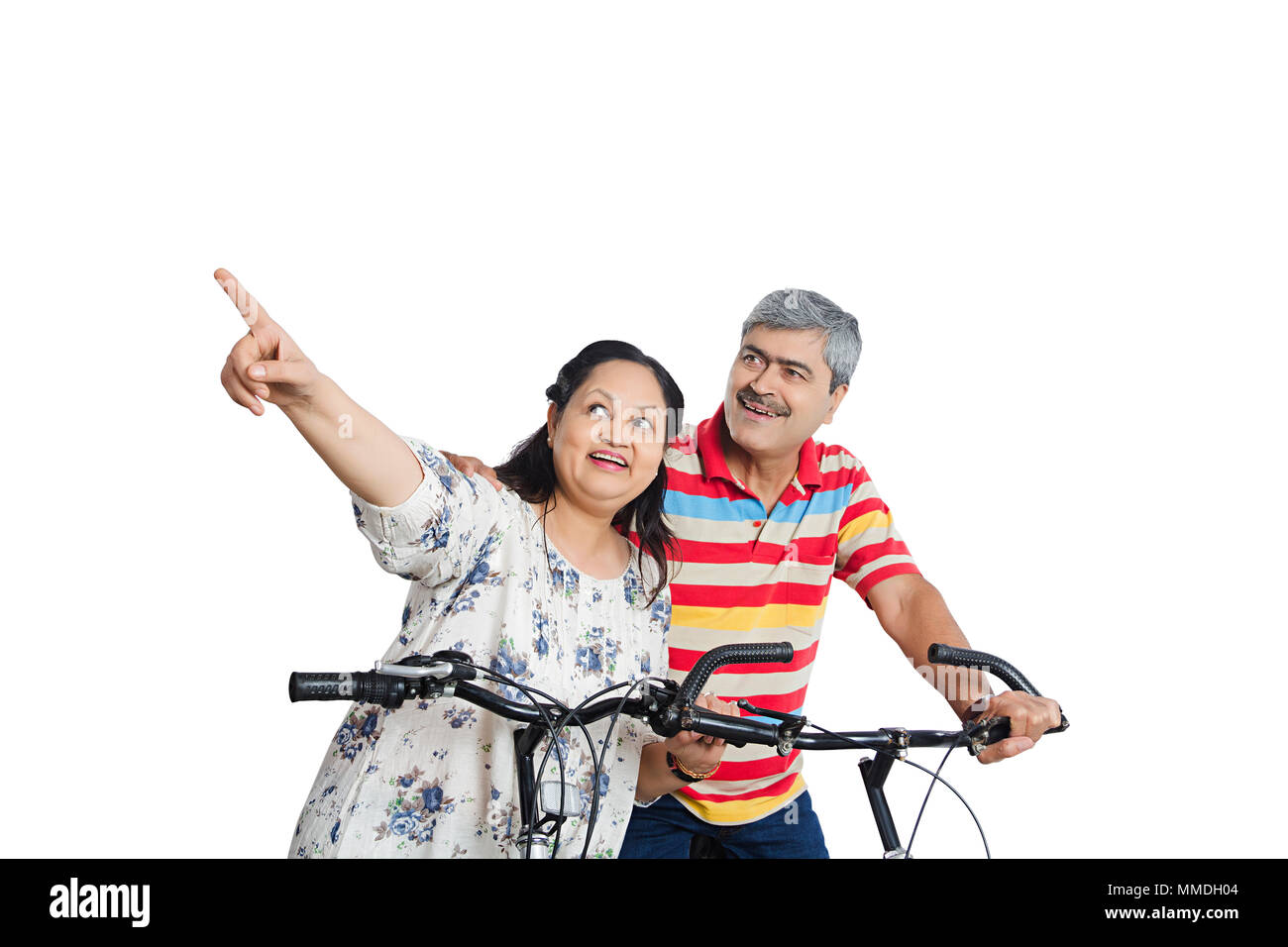 Happy Senior Couple Sitting Cycle While Pointing Finger Showing Stock ...