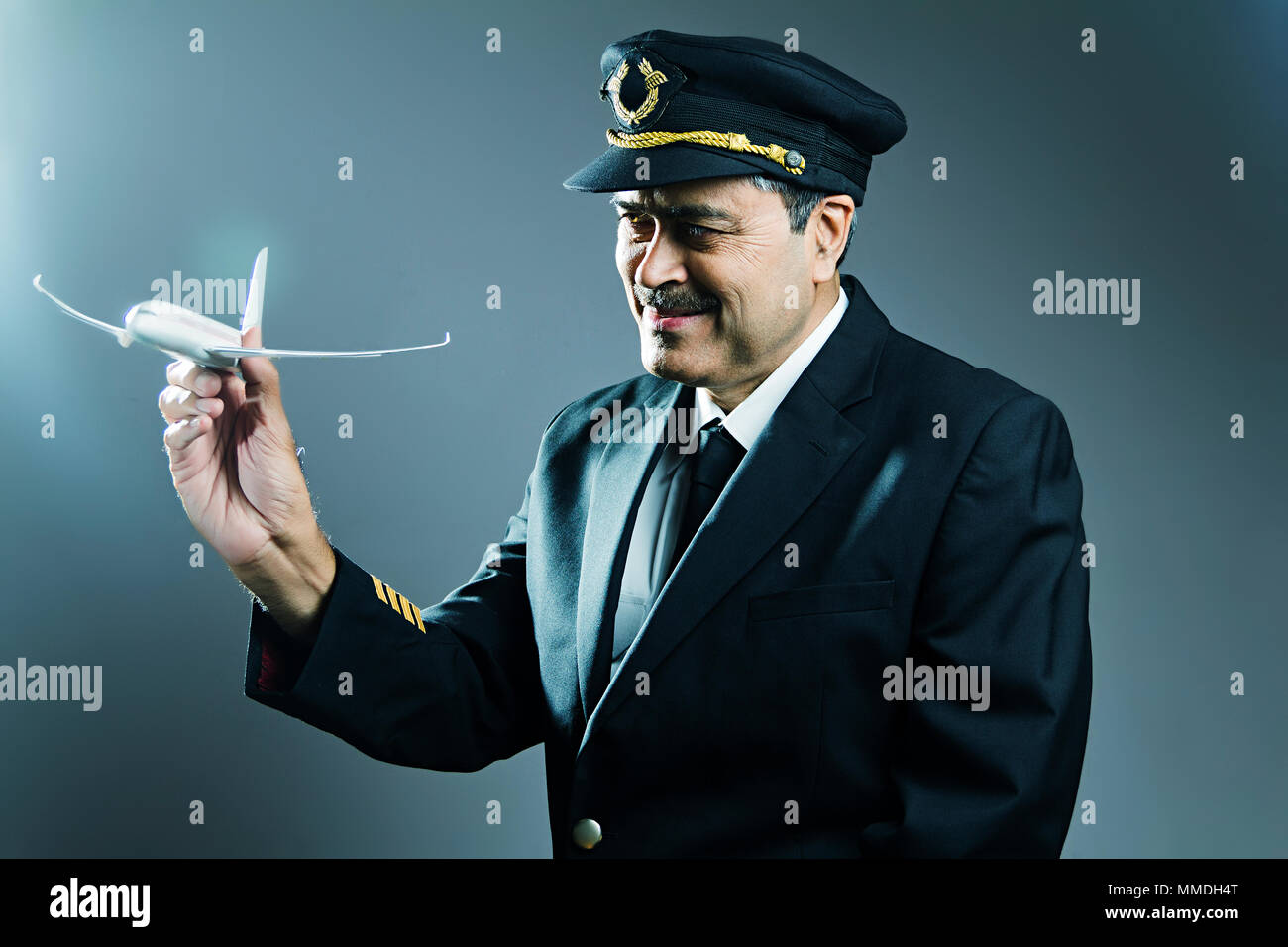 One Senior Man Airline pilot Hand holding a Dummy Airplane Stock Photo ...