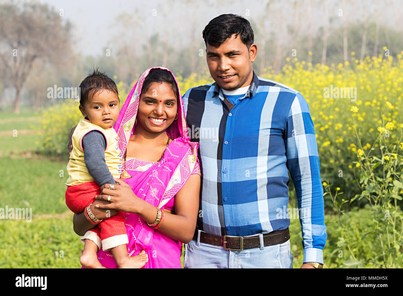 Rural Farmer Villager Parents And Baby Son Standing In-Farm Village ...