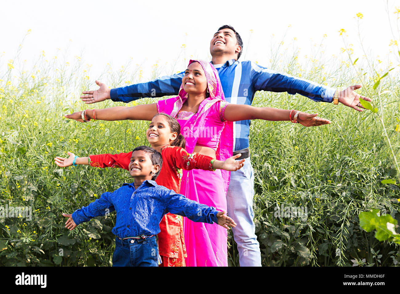 Happy Rural Village Family Parents And kids Arms-Outstretched Together ...
