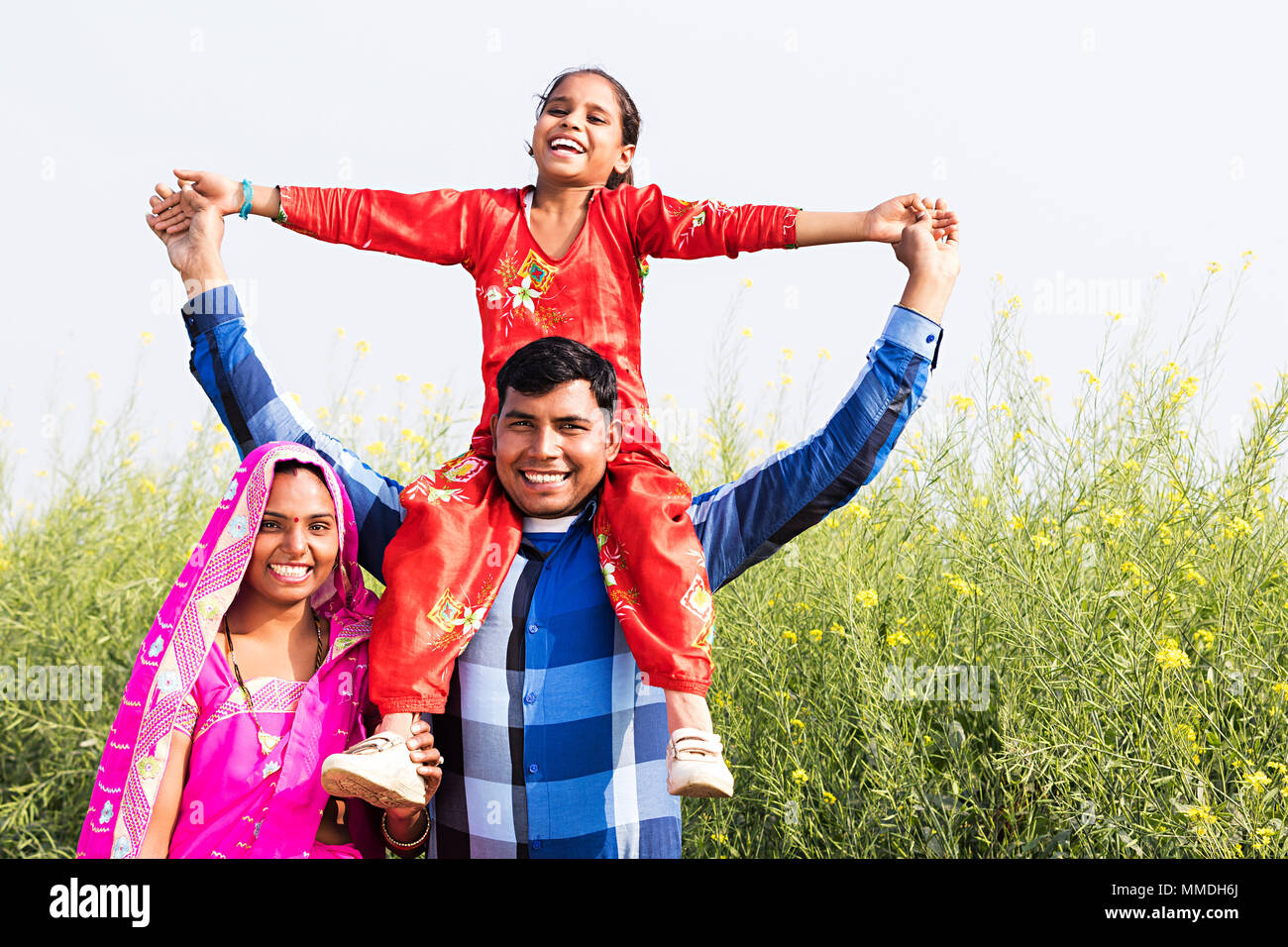 Farmer with daughter standing in mustard field hi-res stock photography ...