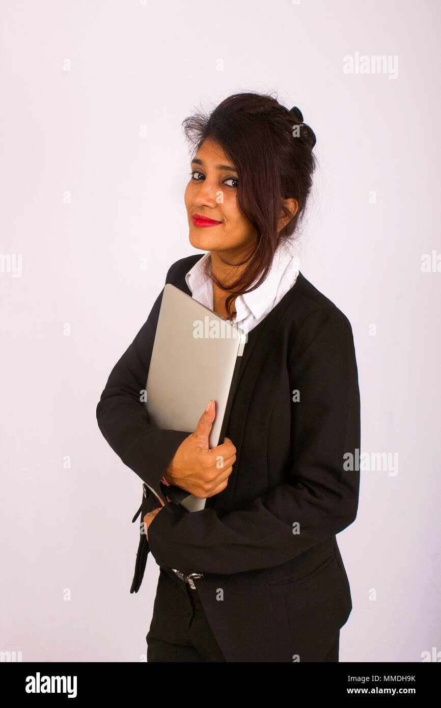 Stylish woman in black suit and laptop looking at camera. Side pose ...