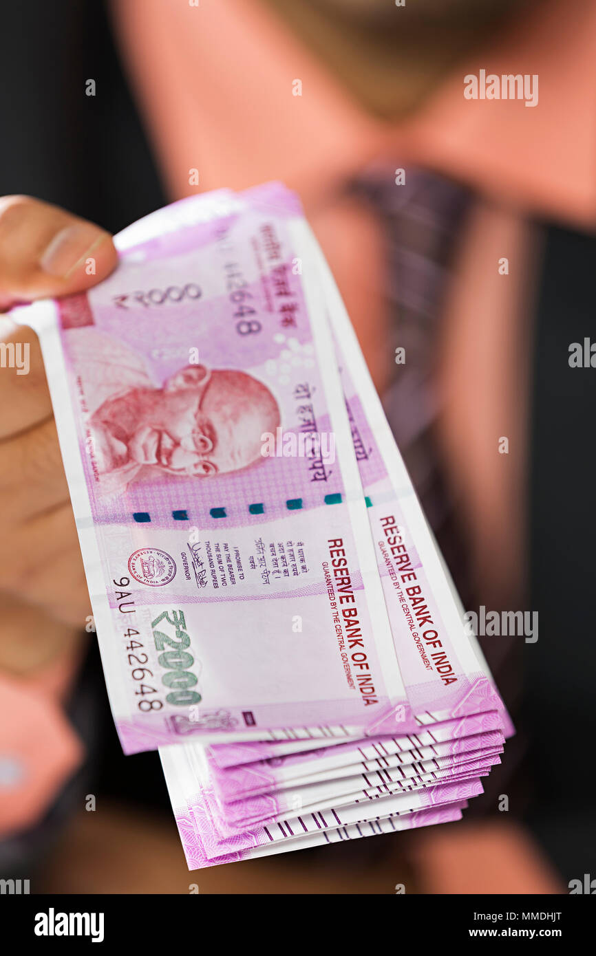 Hand holding indian rupee notes hi-res stock photography and images - Alamy