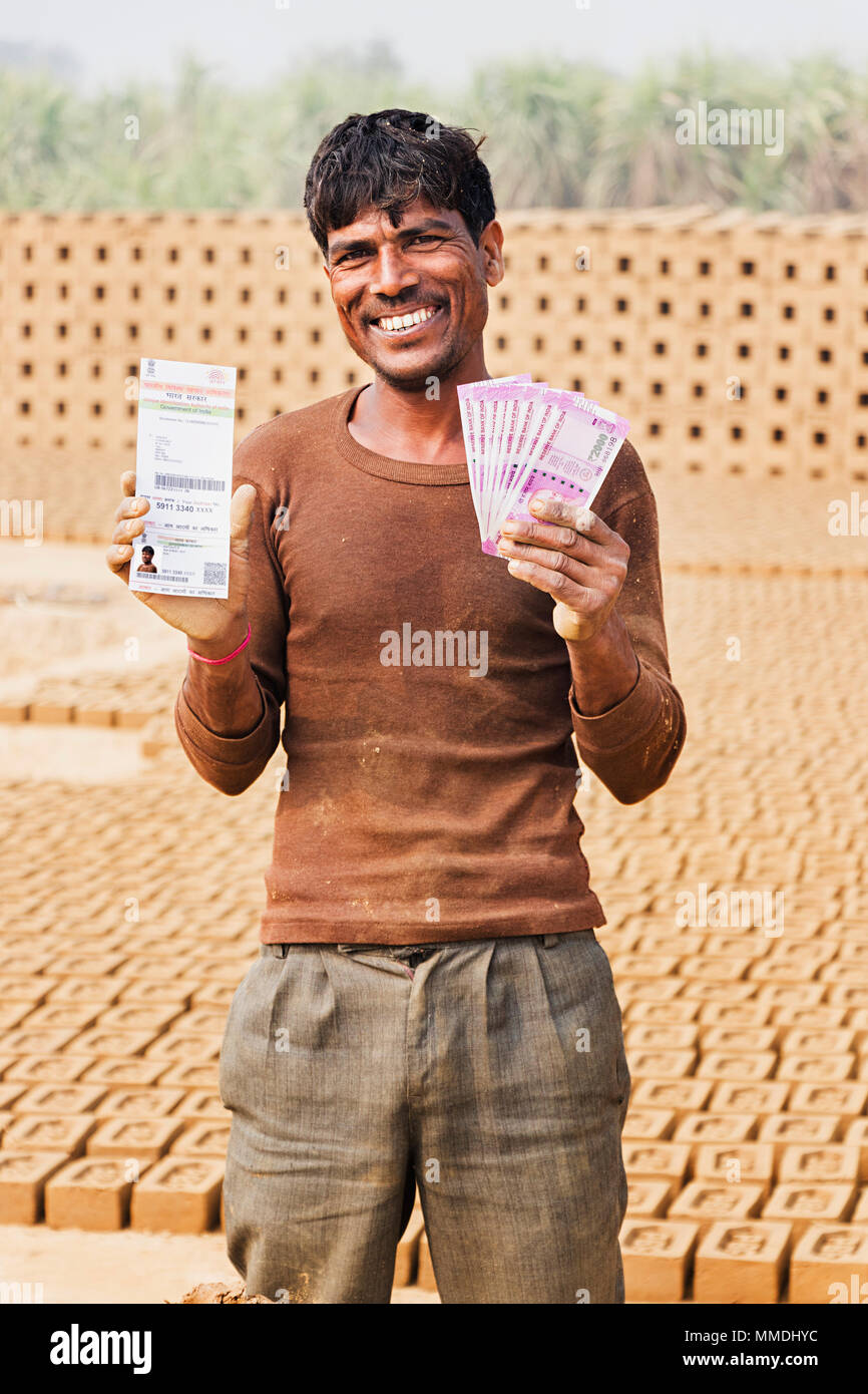 One Labour Male Showing Money With Aadhaar-Card In Village Brick ...