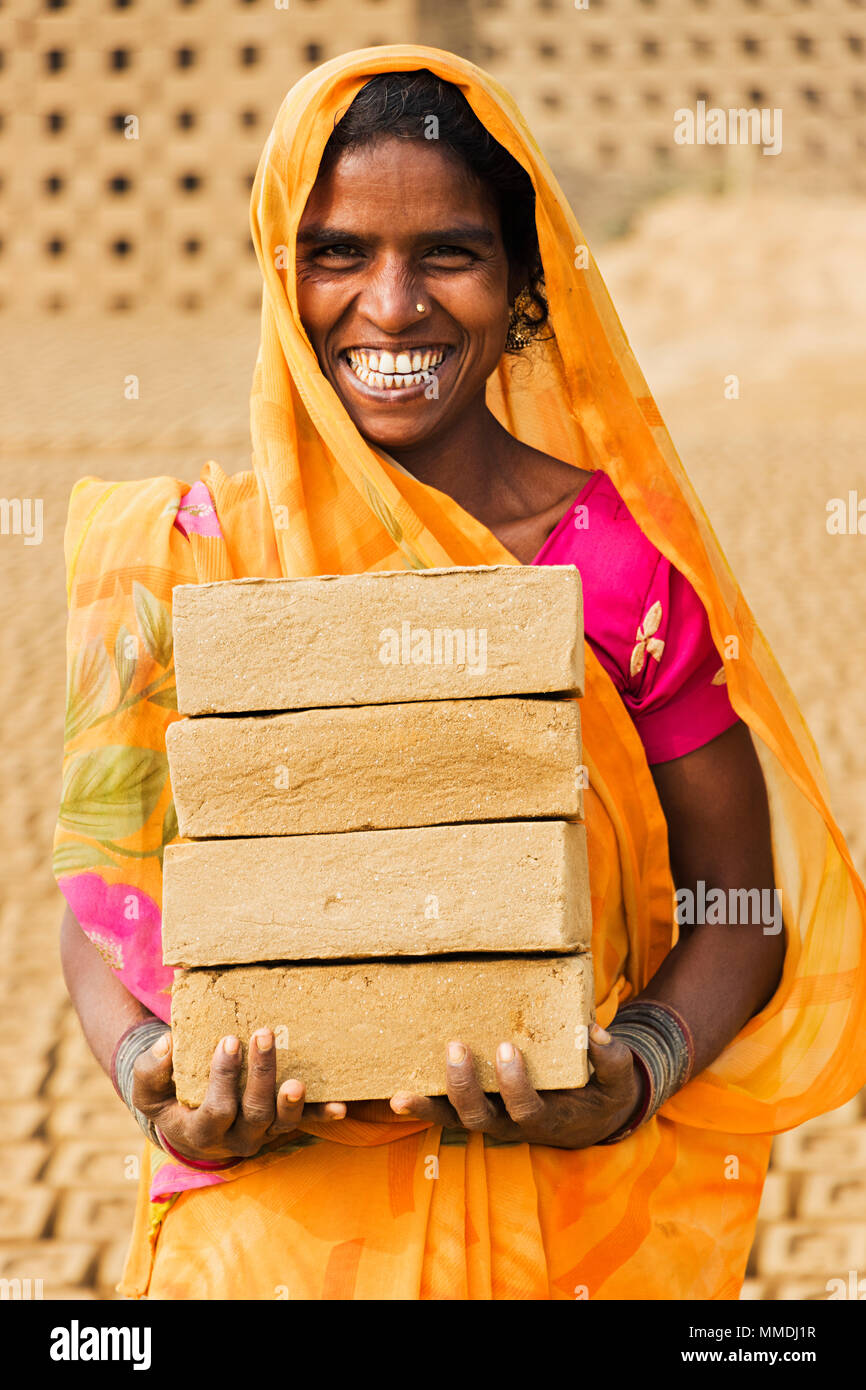 Woman carrying bricks hi-res stock photography and images - Alamy