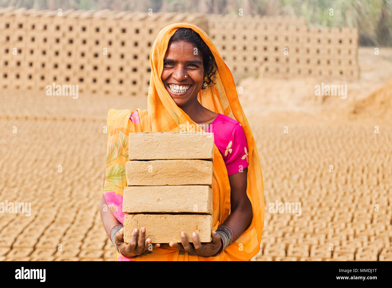 One Rural Female Factory labour carrying stack bricks Works On Brick ...
