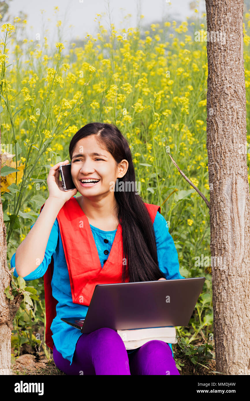 Rural Villager Girl Sitting In-Field Using Laptop And Talking Mobile ...
