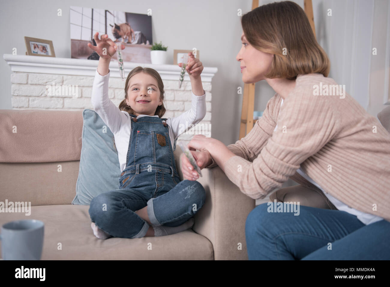Inspired child learning new things with her mom Stock Photo - Alamy