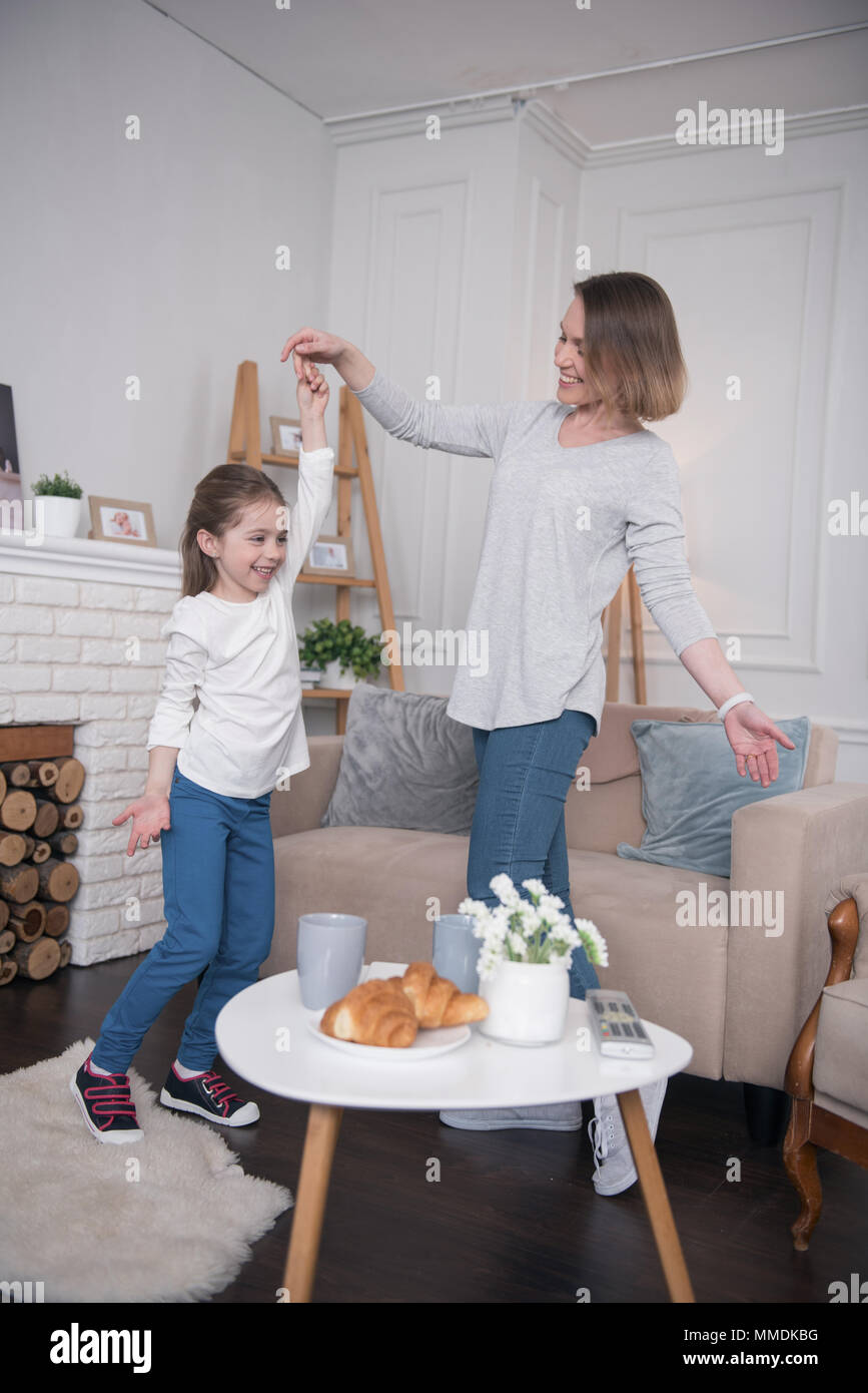 Cheerful girl dancing with her mom Stock Photo - Alamy