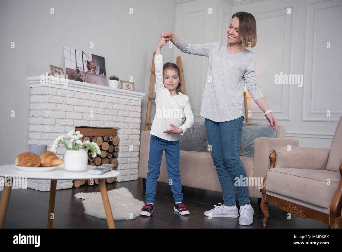 Delighted girl dancing with her mom Stock Photo - Alamy