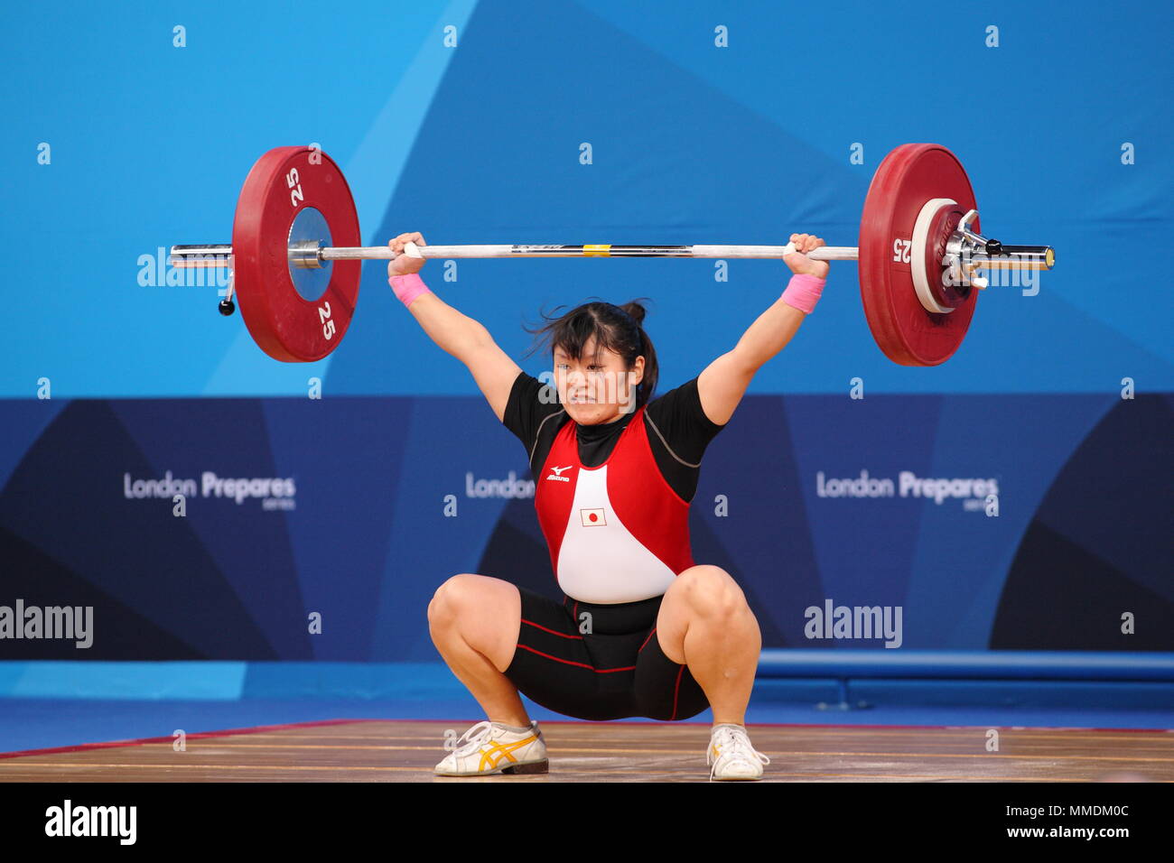 Ayano Tani of Japan competes in the Women's 69kg weight lifting program ...