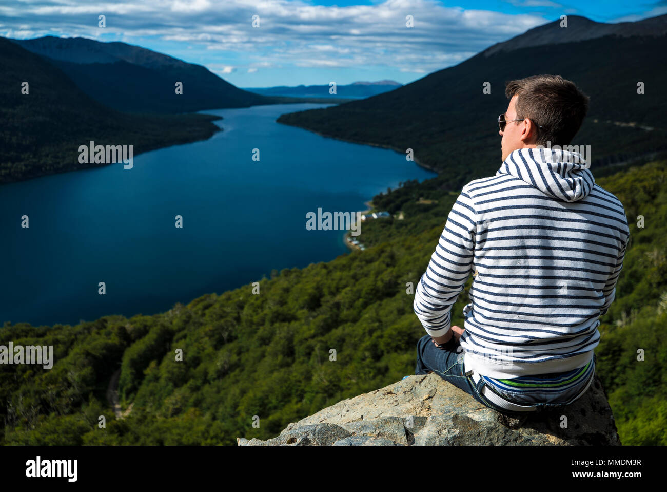 Young man sitting by cliff edge hi-res stock photography and images - Alamy