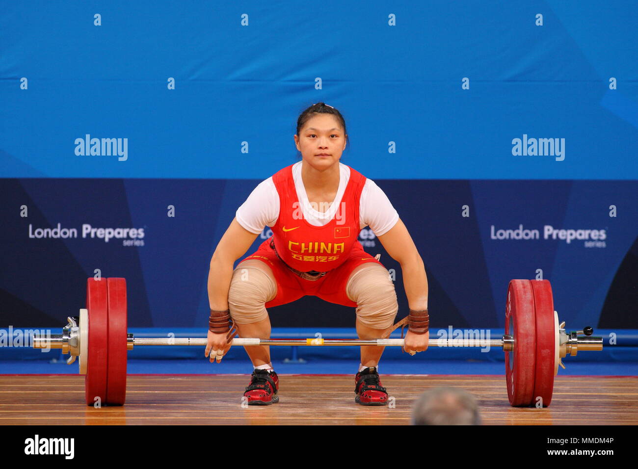 Yue Kang of China competes in the Women's 69kg weight lifting program ...