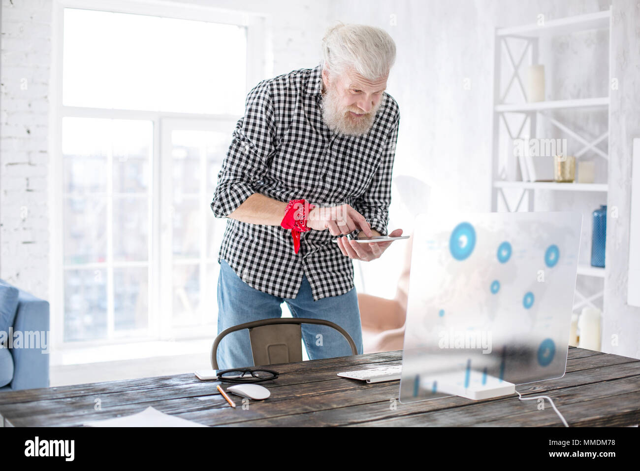 Charming senior man projecting data from tablet onto screen Stock Photo ...