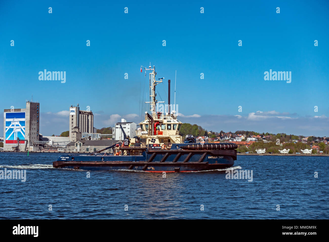 Tug boat Switzer Thor leaving the harbour in Limfjorden Aalborg Jutland ...