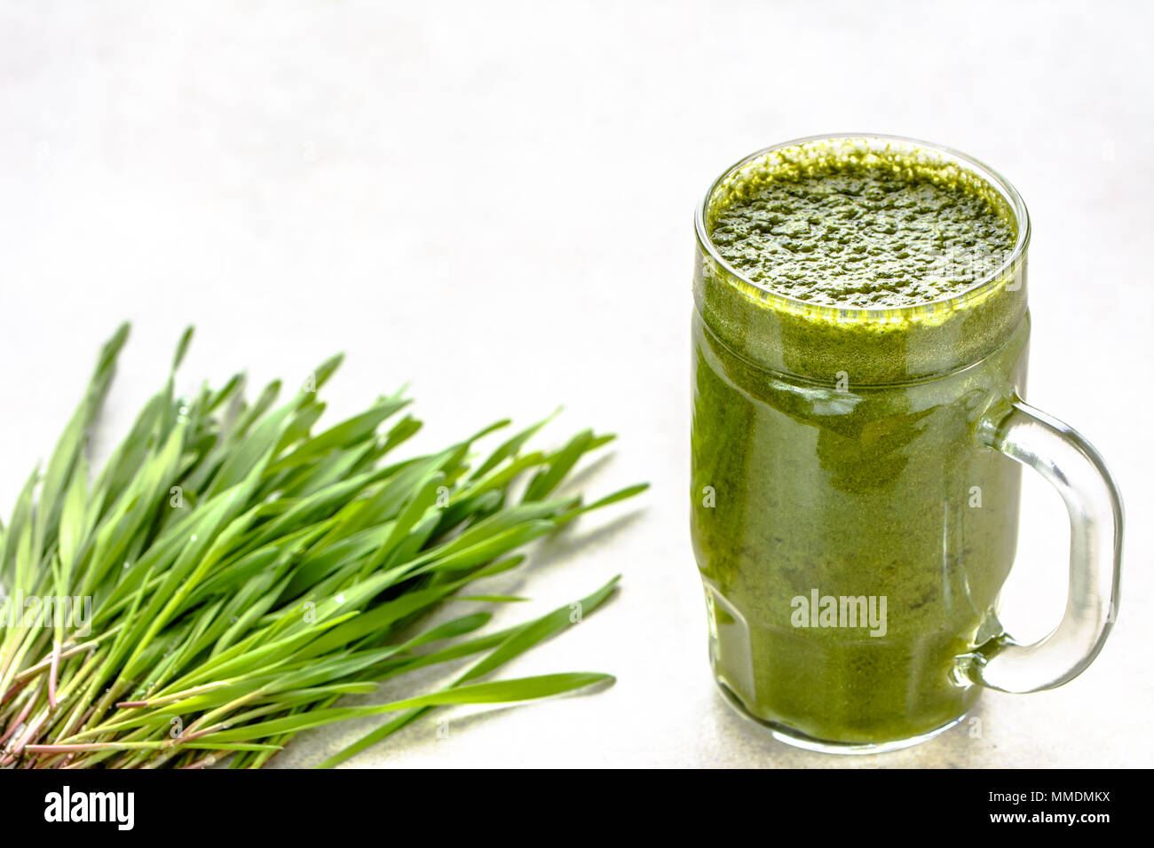 Healthy detox drink with green barley grass, organic juice in jar on ...