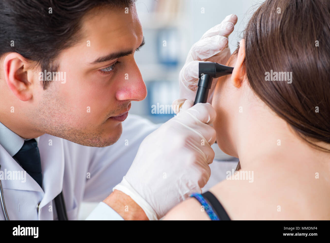 Doctor checking patients ear during medical examination Stock Photo - Alamy