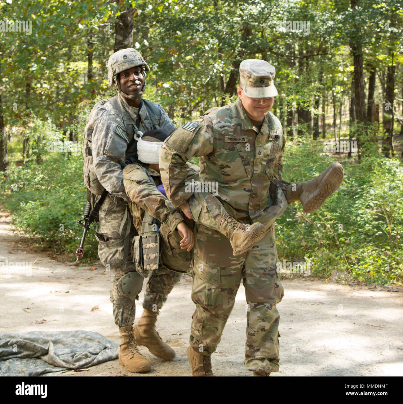U.S. Army Expert Field Medical Badge (EFMB) candidates carry a casualty ...