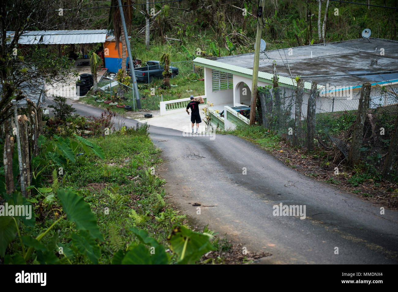 Ricardo Declet, a volunteer from San Juan, Puerto Rico, walks a box of ...