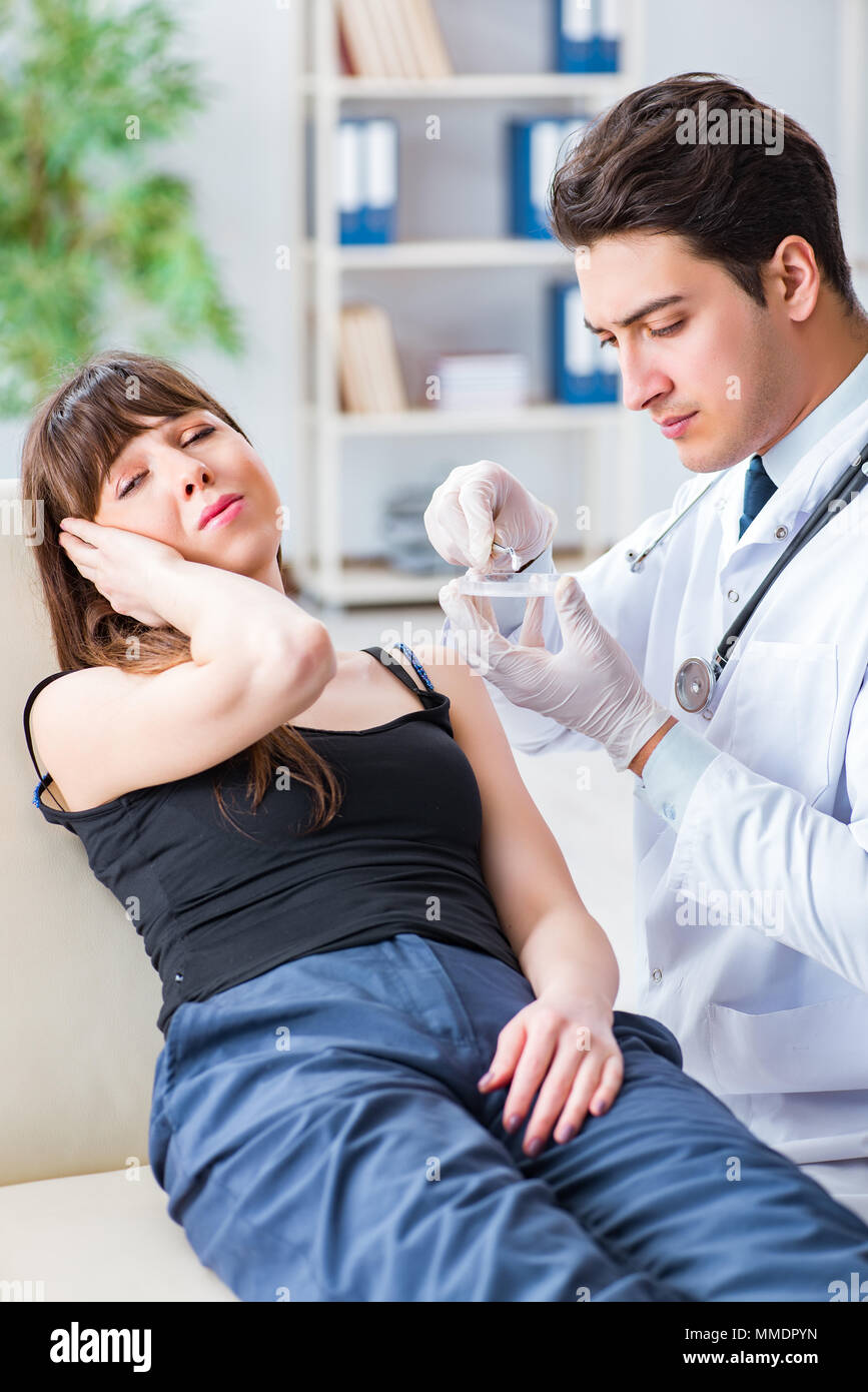 Doctor checking patients ear during medical examination Stock Photo - Alamy
