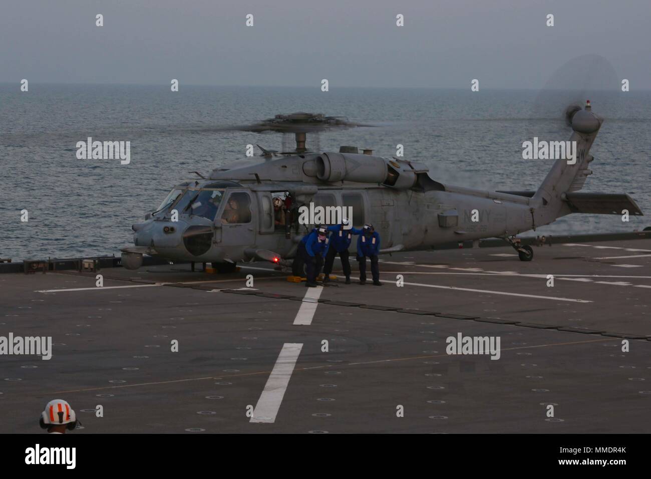Sailors support a MH-60 Seahawk Helicopter aboard USS Lewis B. Puller ...