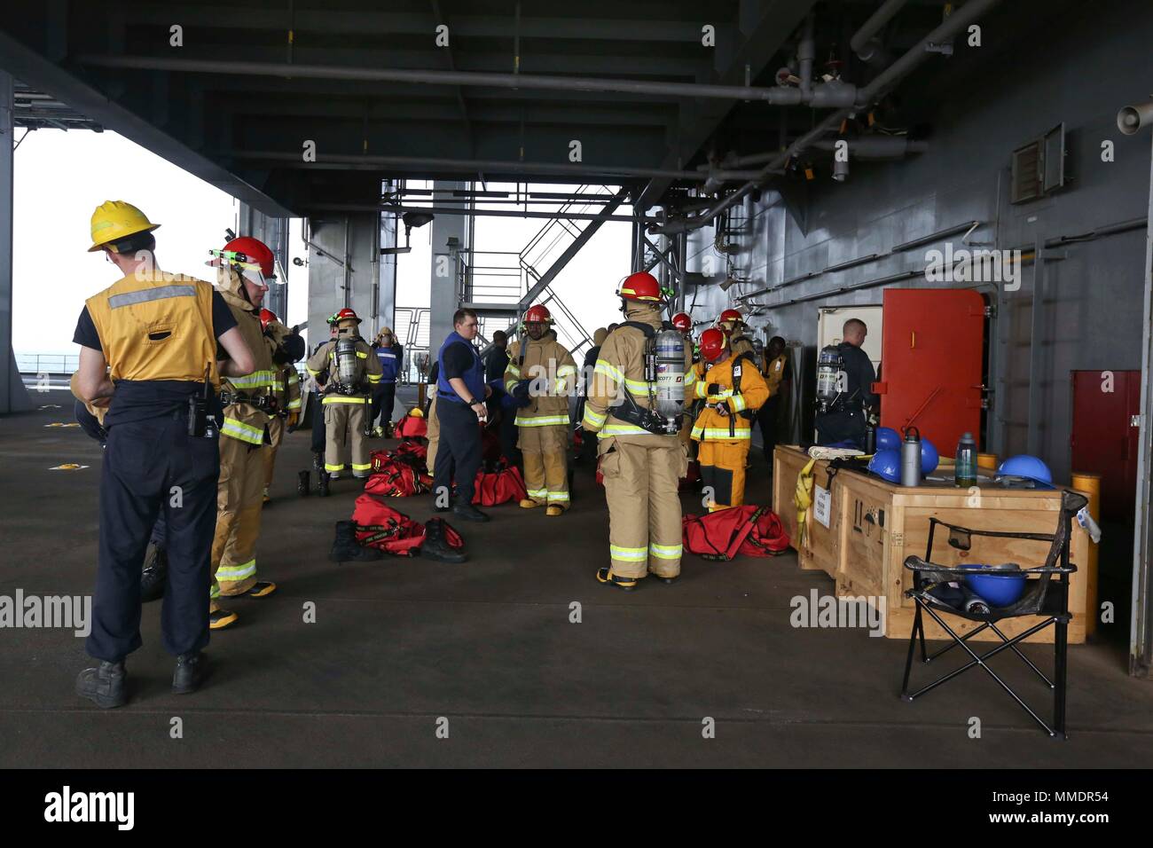 Sailors don protective gear during a fire evacuation drill aboard USS ...