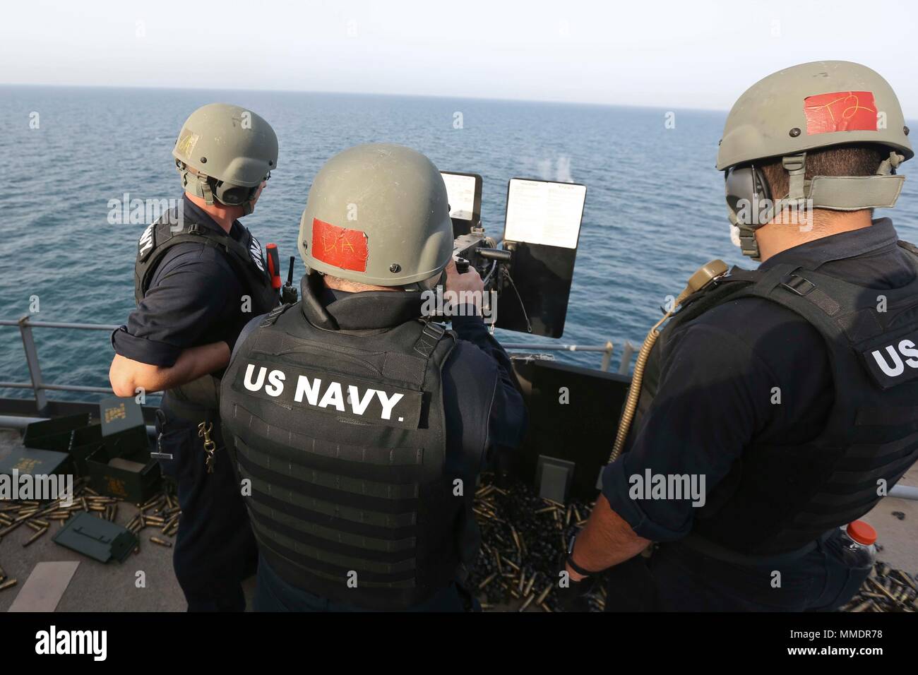 Navy Capt. Joseph D. Femino, commanding officer of USS Lewis B. Puller, fires a .50-caliber ...