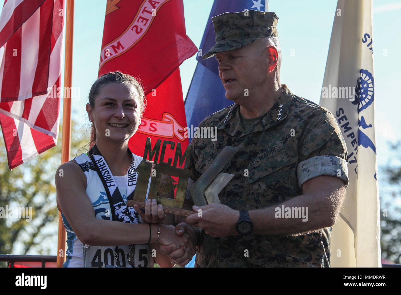 Commandant of the Marine Corps Gen. Robert B. Neller, right, presents a ...