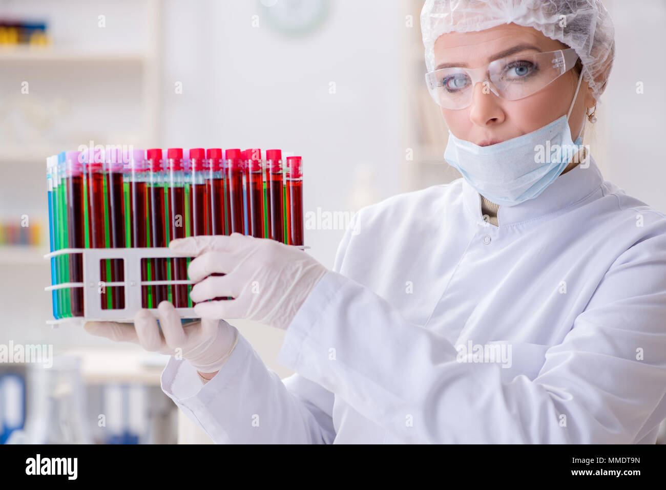 Woman doctor checking blood samples in lab Stock Photo - Alamy