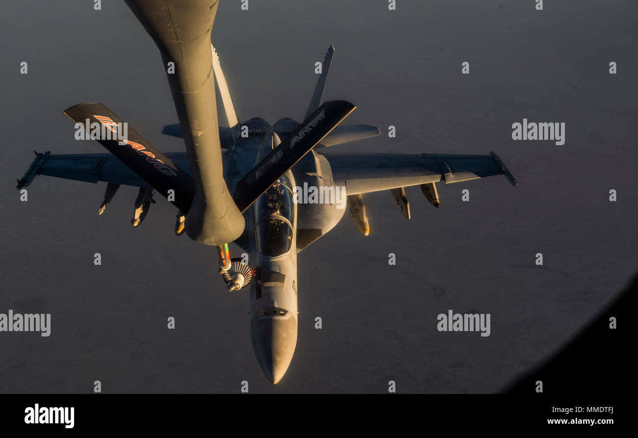 A U.S. Navy F/A-18 conducts aerial refueling operations with a KC-135 ...