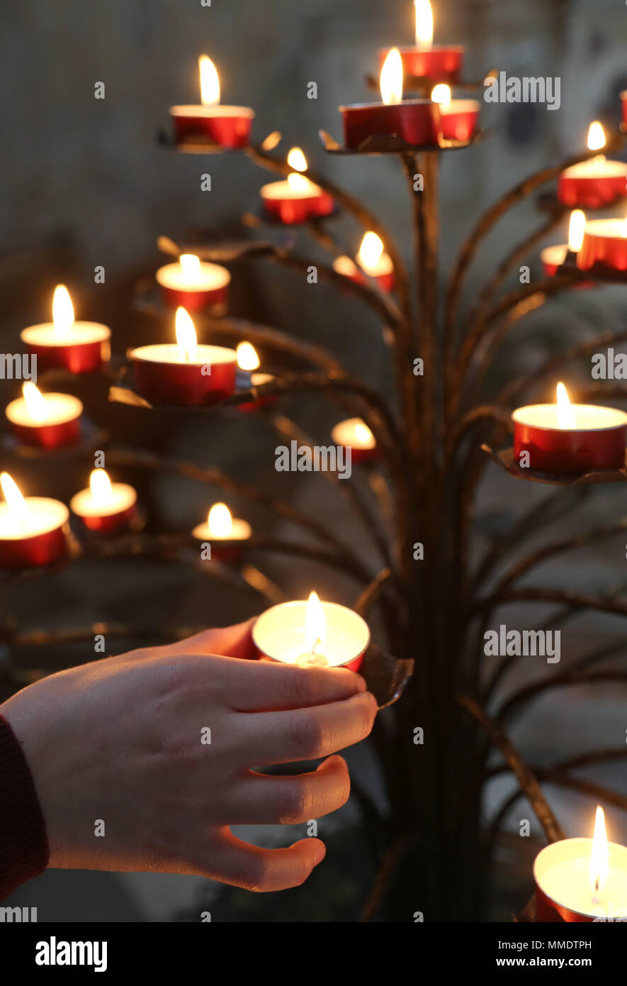 hand of child takes a candle in the church during the holy mass Stock ...