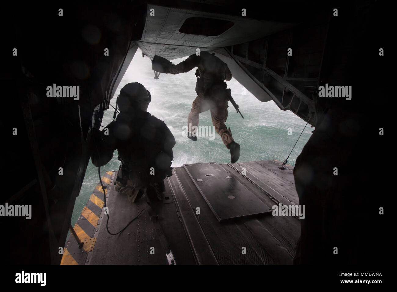 A student of the Recon Team Leaders Course (RTLC) jumps out of the back ...