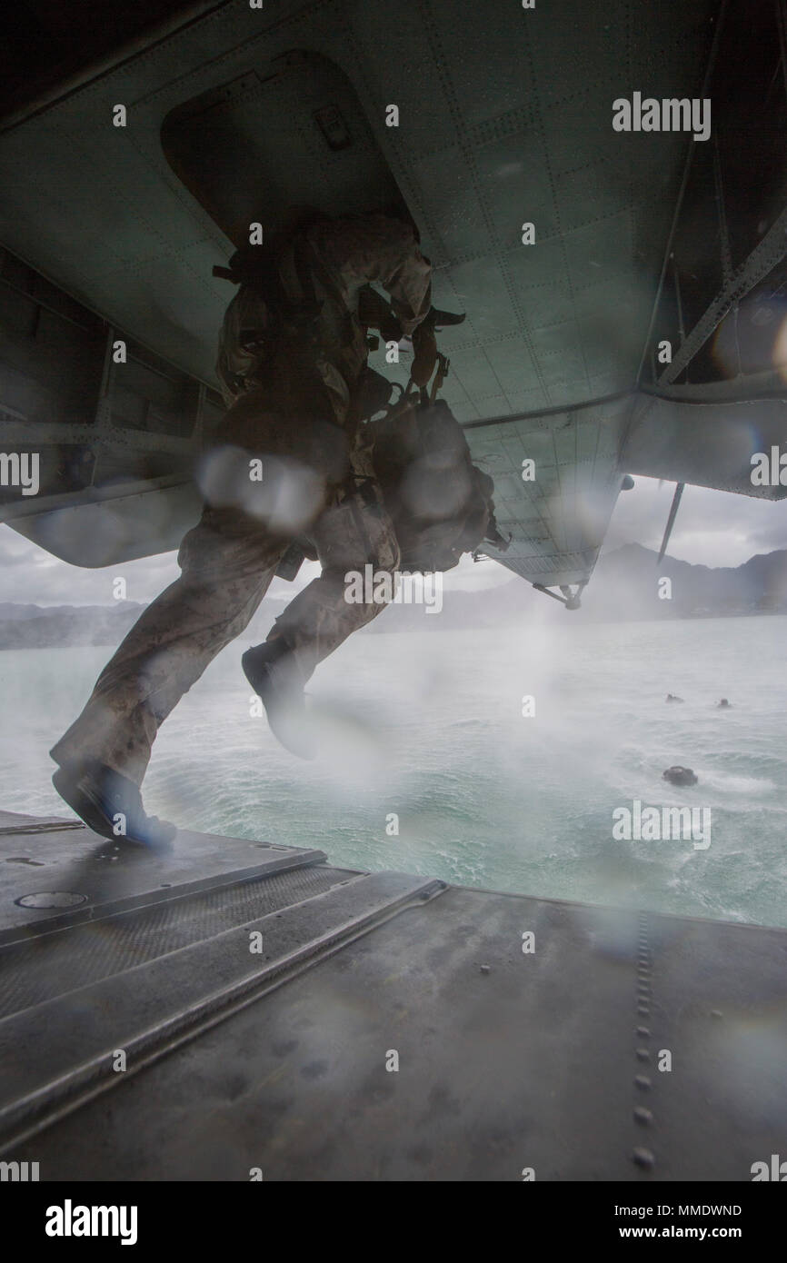 A student of the Recon Team Leaders Course (RTLC) jumps out of the back ...