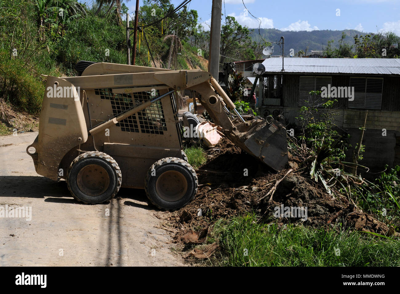 A skid-steer loader, driven by Spc. Elliot Knight, 130th Engineer ...