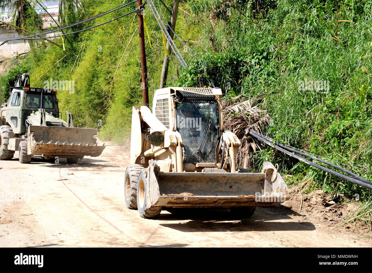 A skid-steer loader driven by Spc. Elliot Knight, and a backhoe loader ...
