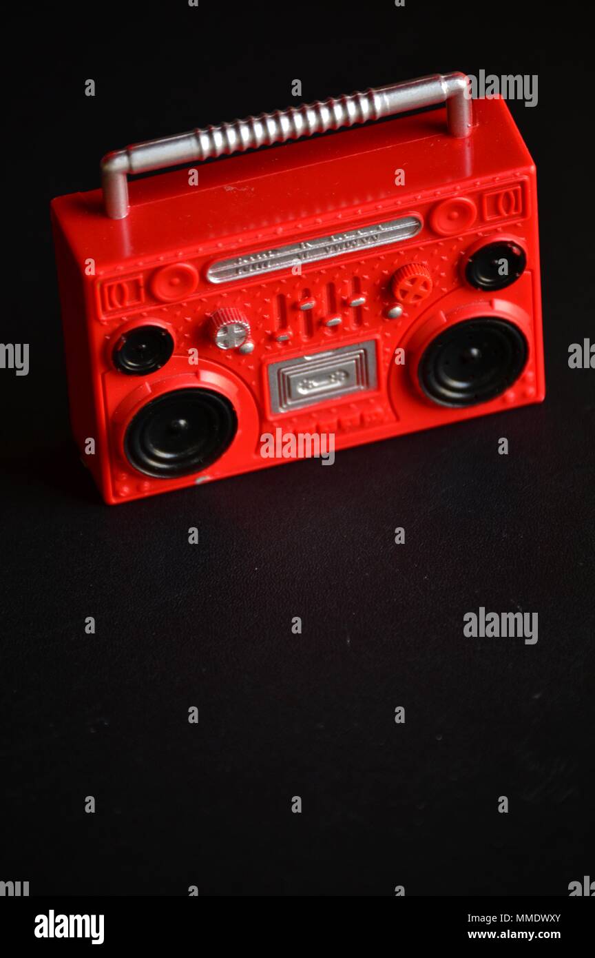 Red music player on black background Stock Photo - Alamy