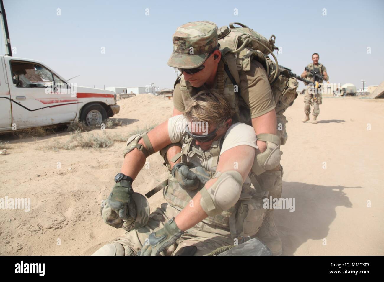 U.S. Army Soldiers of 1st Calvary Division demonstrate a buddy carry ...